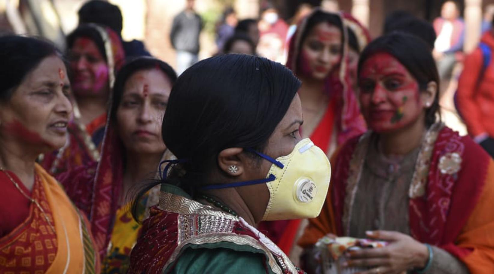 India: Holi celebrated with face masks and color explosions amid ...